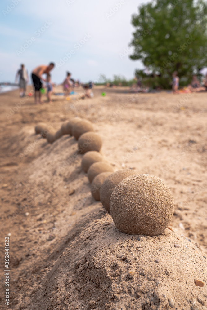 Close up view of an undulating sand castle hill or wall with perfectly ...