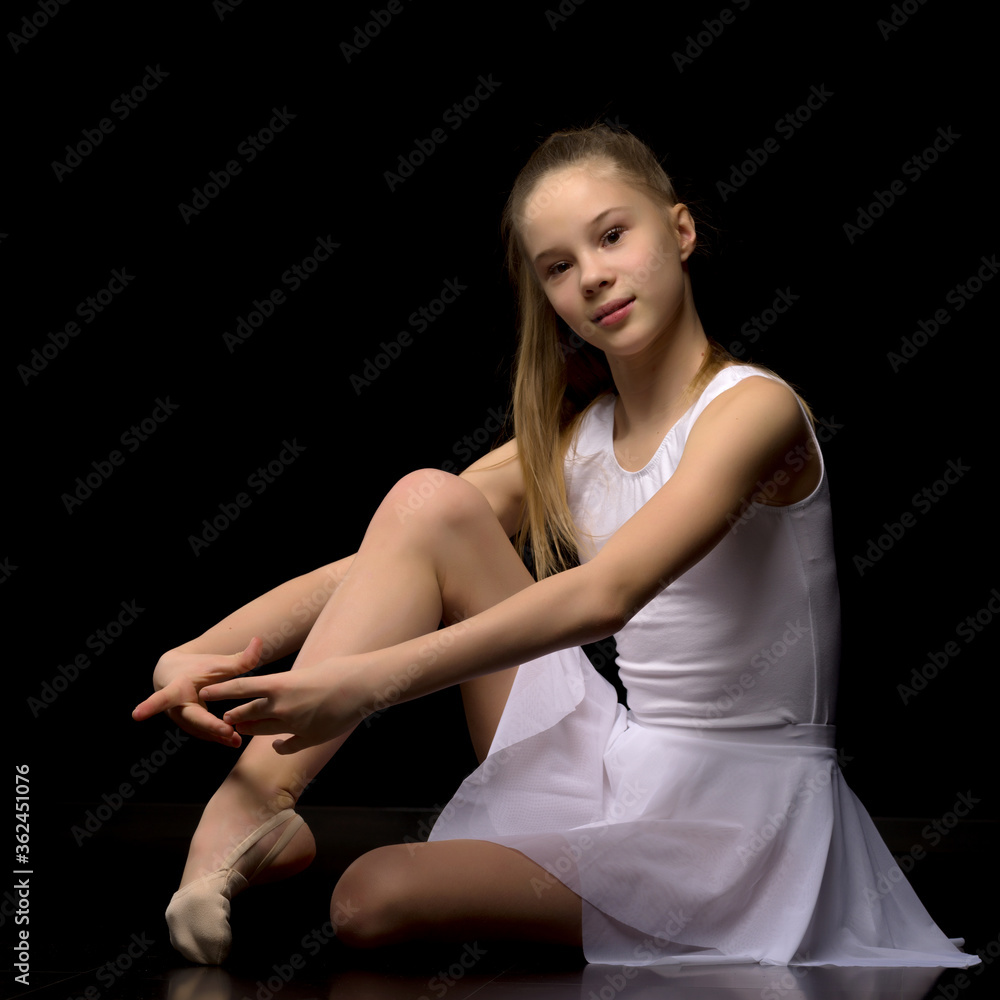 of Lovely Preteen Girl Sitting on the Floor Hugging Her Knees Stock ...