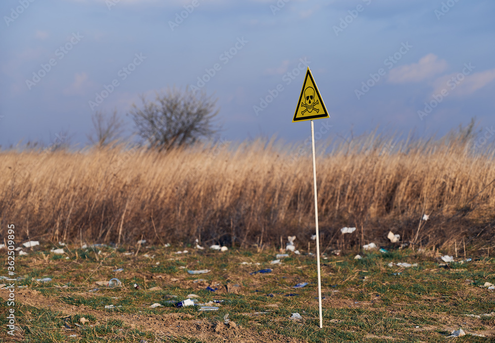 Yellow triangle with skull and crossbones symbol on abandoned territory ...