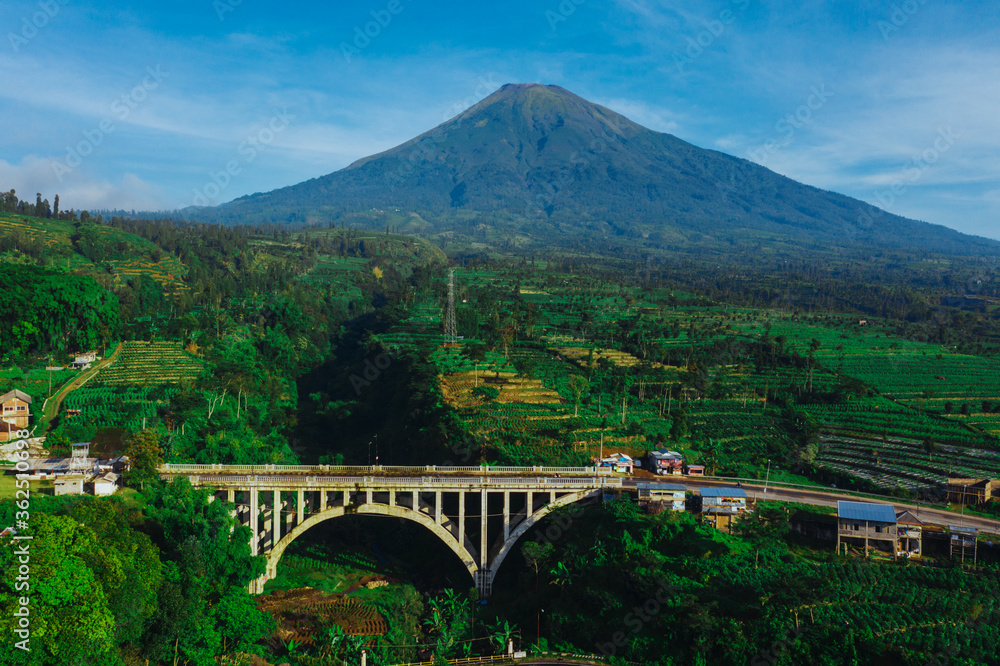 Morning view of Sigandul Bridge with Sindoro mountain baground. Stock ...