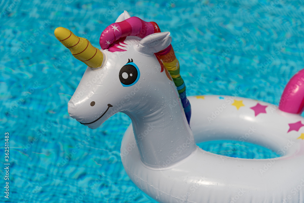 Inflatable unicorn floating in swimming pool. Unicorn inflatable pool ...
