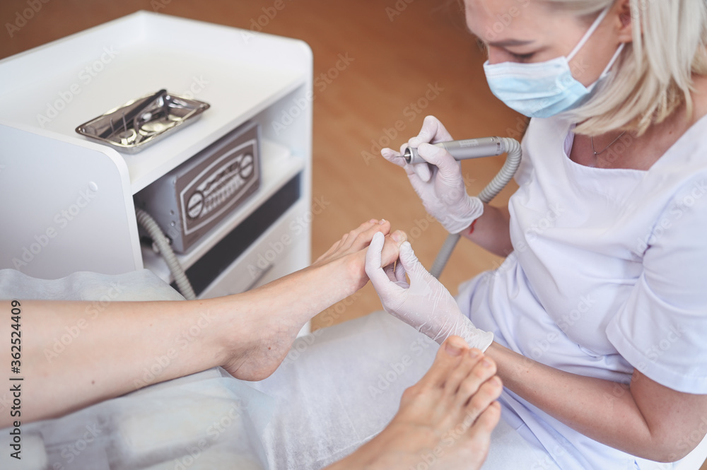 Hardware medical pedicure with nail file drill apparatus. Patient on ...