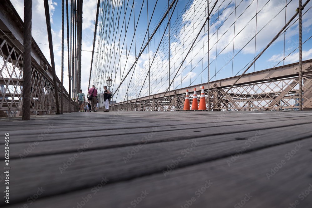Low angle view of the famous Brooklyn Bridge in New York, USA. One of ...