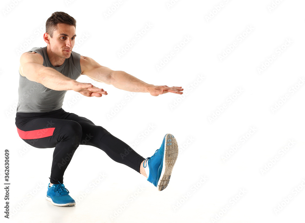 Young muscular man showing one leg squat exercise isolated on white ...