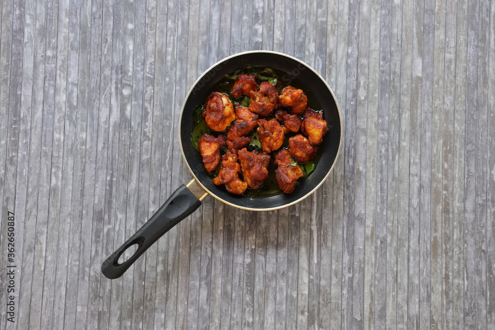 Chicken fry or Fried chicken kabab which is well garnished with curry ...