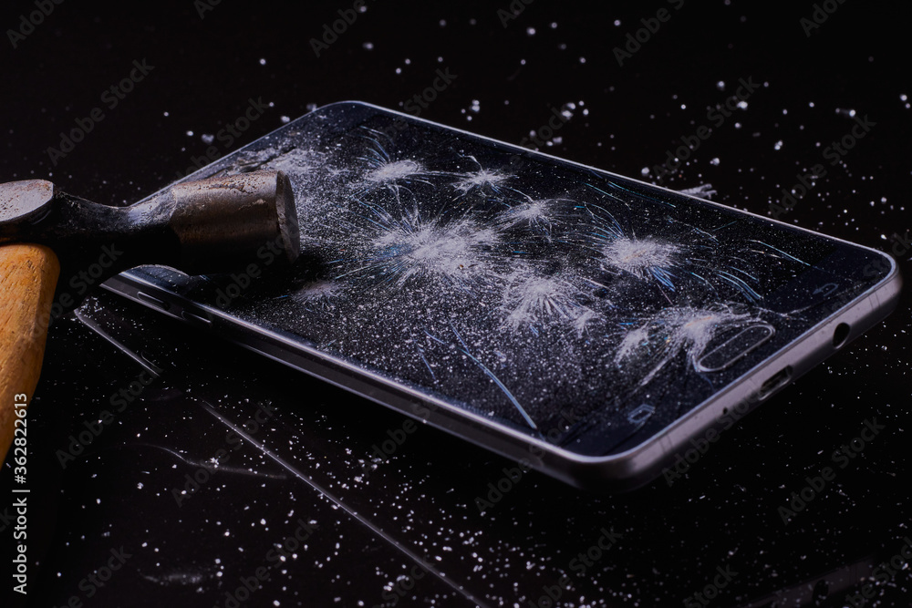 Digital detox concept smart phone that has been smashed with hammer and ...