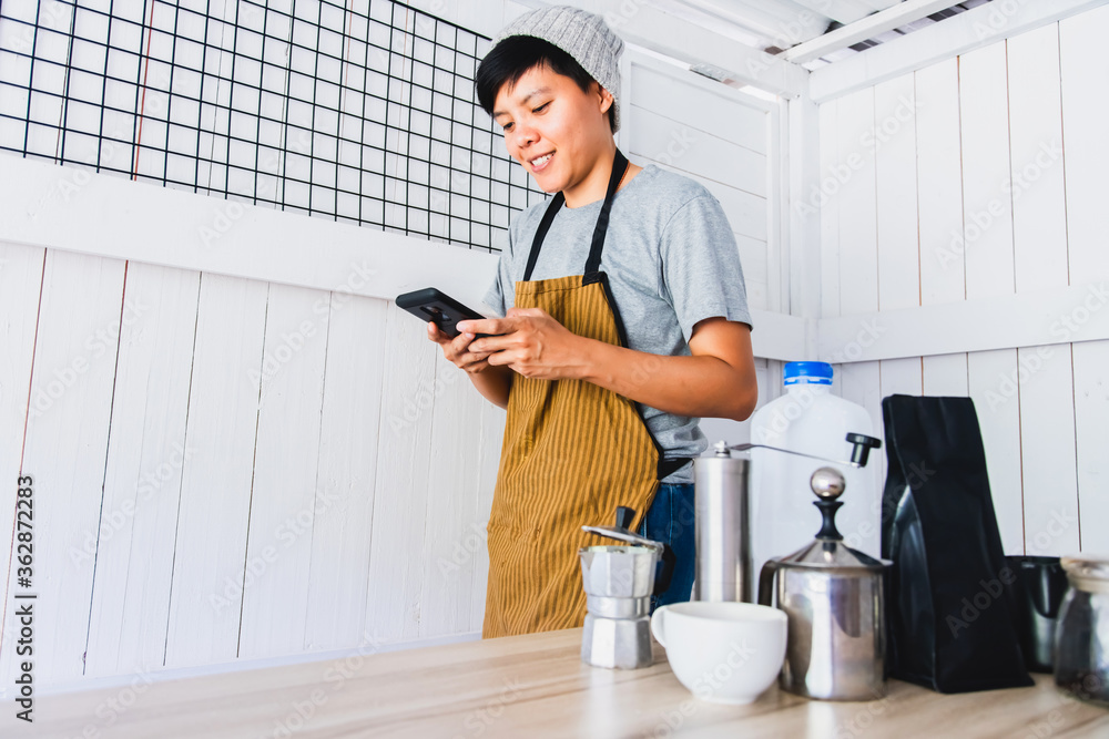 coffee shop owner smile using a phone order to confirm the coffee menu ...