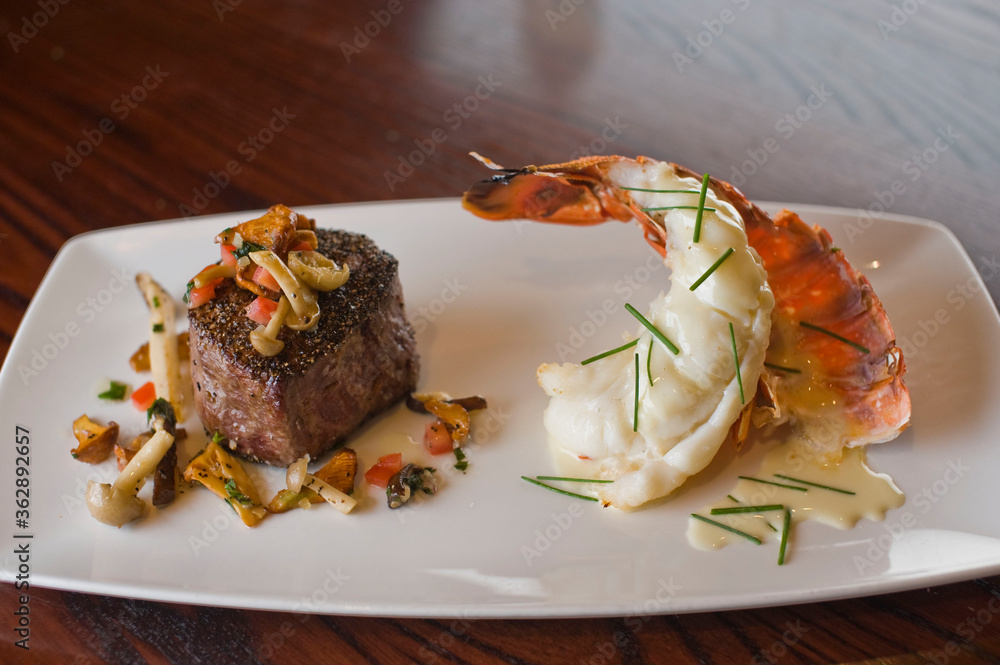 Surf ‘n Turf, lobster tail and steak entree. Filet mignon topped with ...