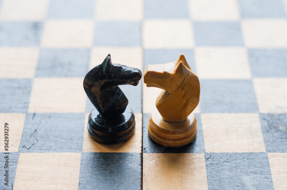 Face Off. Chess pieces knights facing each other for a standoff on ...