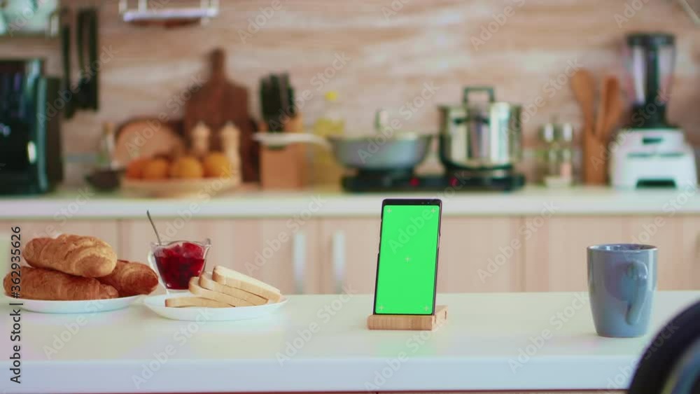 Smartphone with green screen in kitchen with nobody in it. Green screen ...