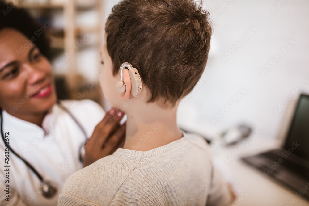 Smiling deaf boy with ear implant at doctor's office. Stock Photo ...