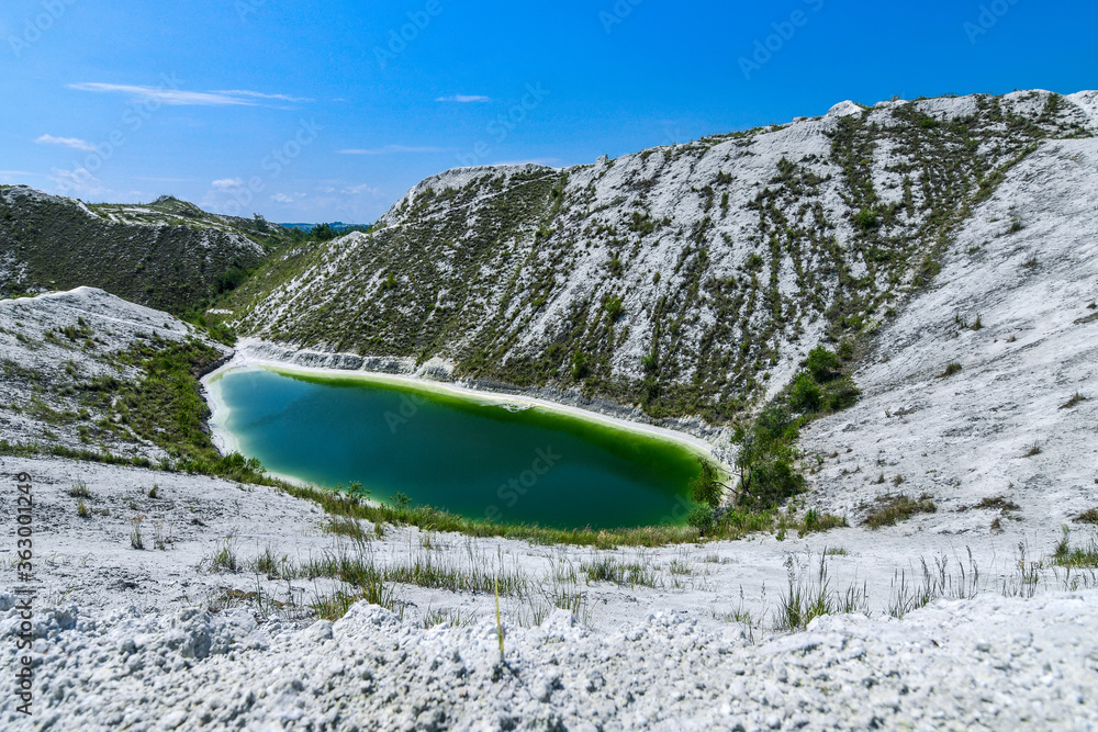 Lake with blue transparent water in the white mountains. Deserted hills ...
