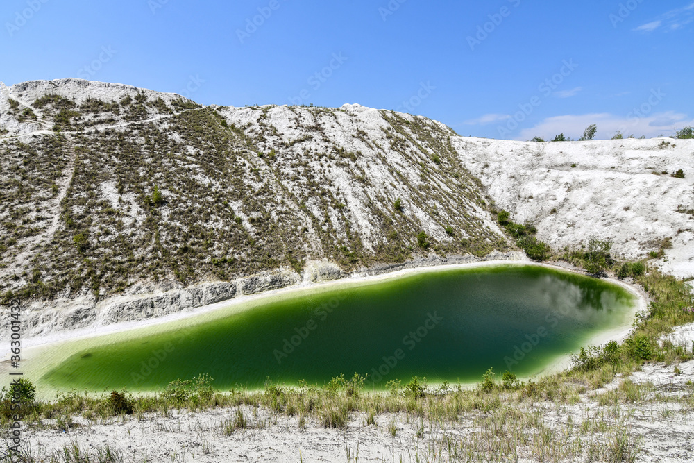 Lake with blue transparent water in the white mountains. Deserted hills ...