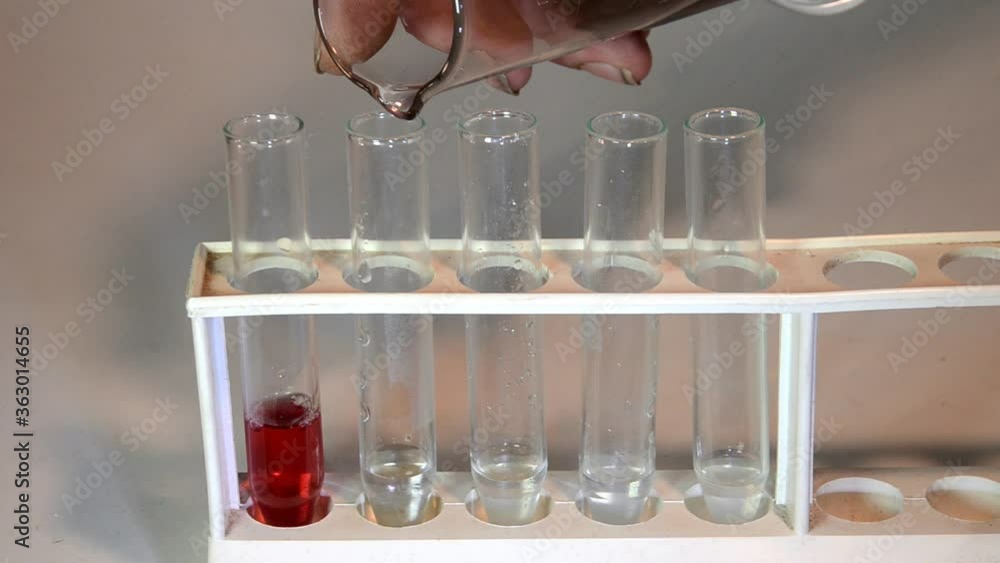 Extract of red cabbage is poured into test tubes with liquids of ...