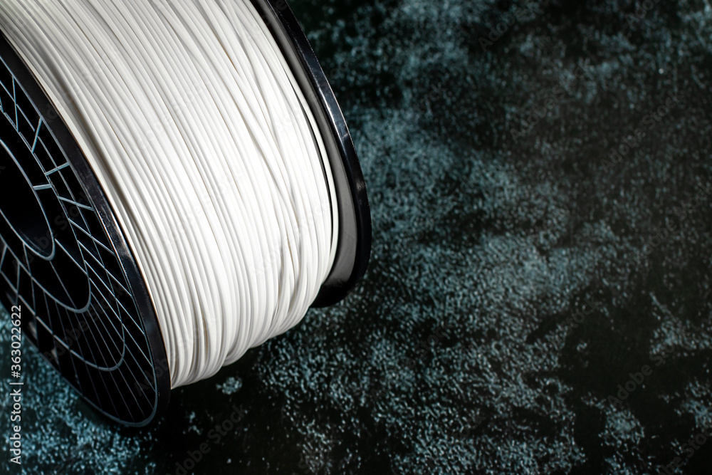 Filament for 3d printing. Bright thermoplastic of white color. Reel ...