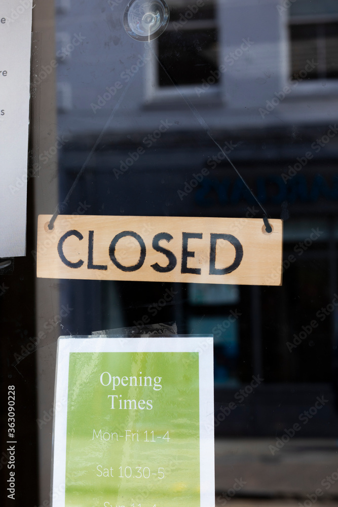 Hand written closed sign in retail shop door window with some ...