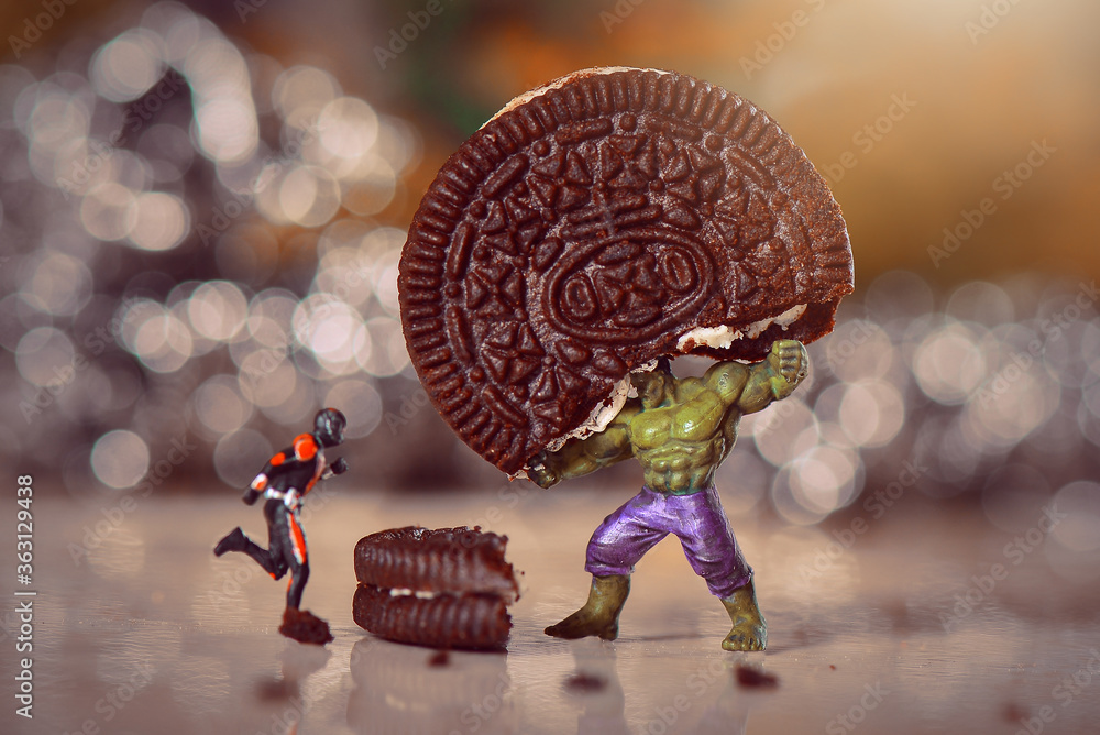The figure of the mini hulk lifts the biscuits Stock Photo | Adobe Stock
