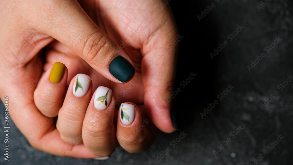 Women's hands with colorful patterns on the nails. Summer colors trend ...
