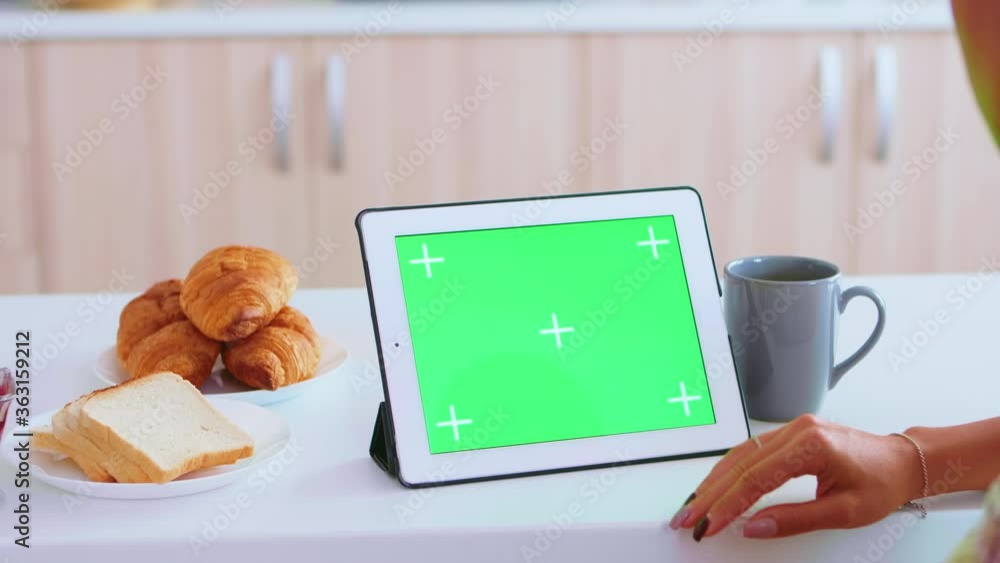 Video Stock Woman zooming in on tablet pc with green screen during ...