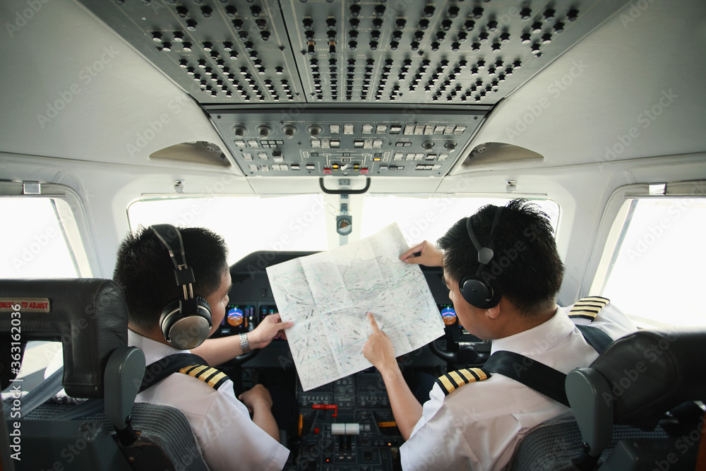 Pilot and co-pilot in private jet cockpit Stock Photo | Adobe Stock