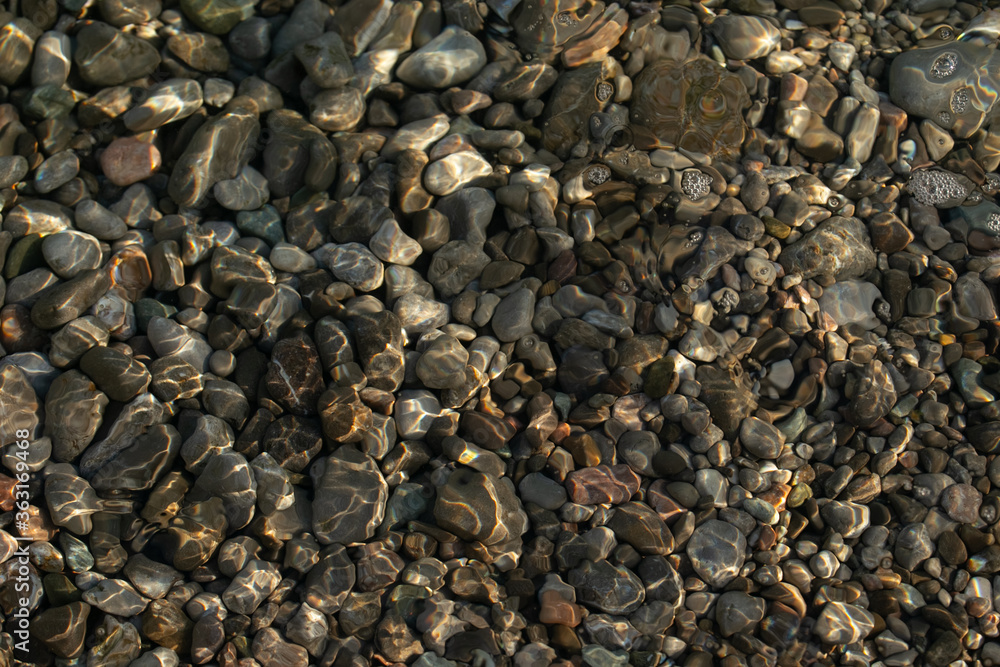 Pure water. Stones in the water on the black sea. Shallow water. Stones ...
