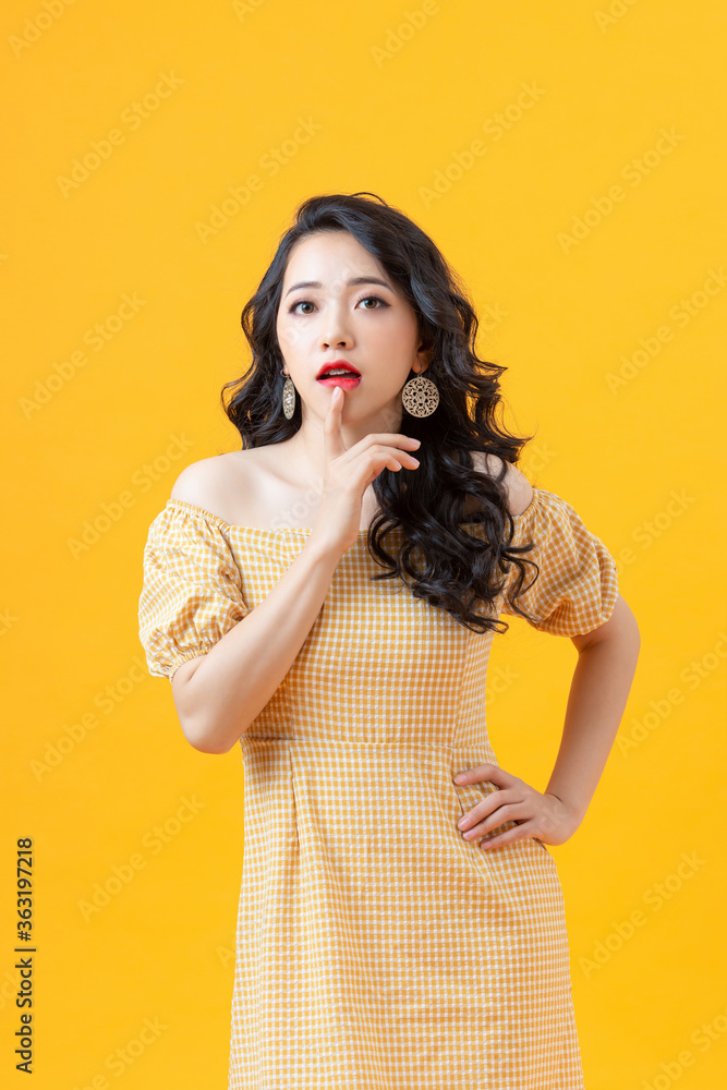 Beautiful woman touching lips, looking at camera with cunning smile and ...