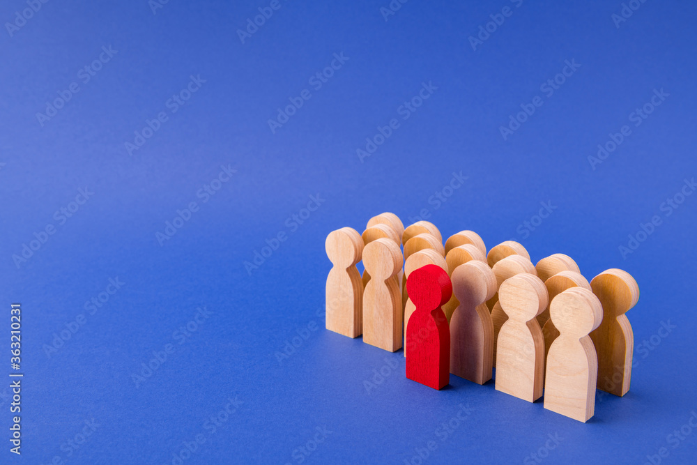 Wooden faceless figures of employees standing behind their leader ...