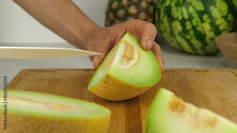 Gutting the seeds from a chunk of melon Stock Video | Adobe Stock