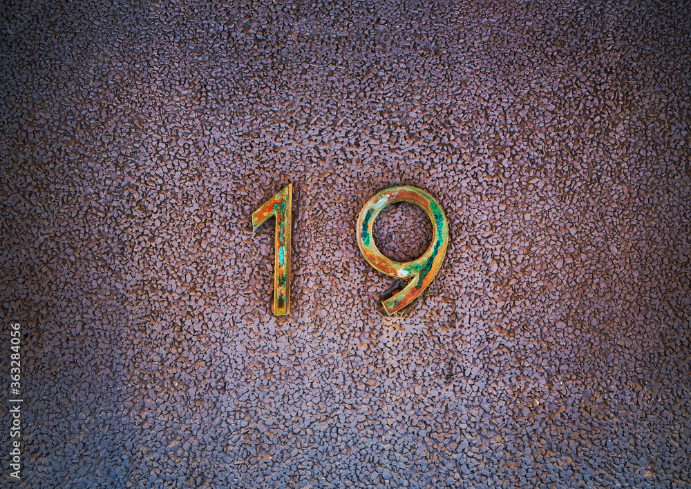 Elegant art deco number 19, nineteen, on dark background with slight ...