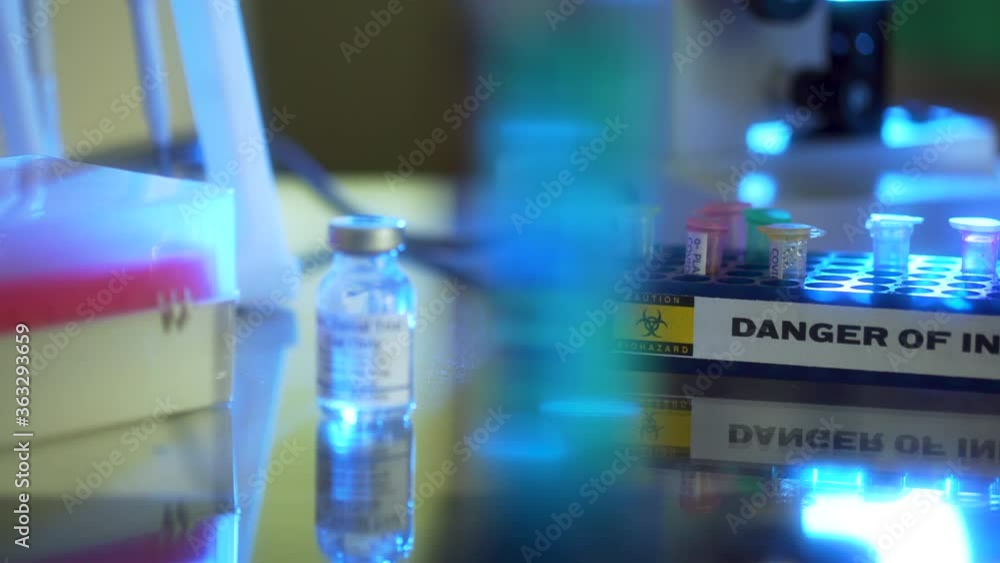 Scene tracks past a testing laboratory of covid19 vials and trial ...