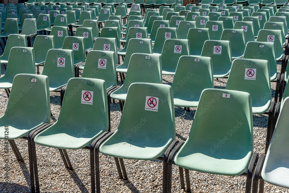 Social distancing with chairs on which the Italian words "vietato ...