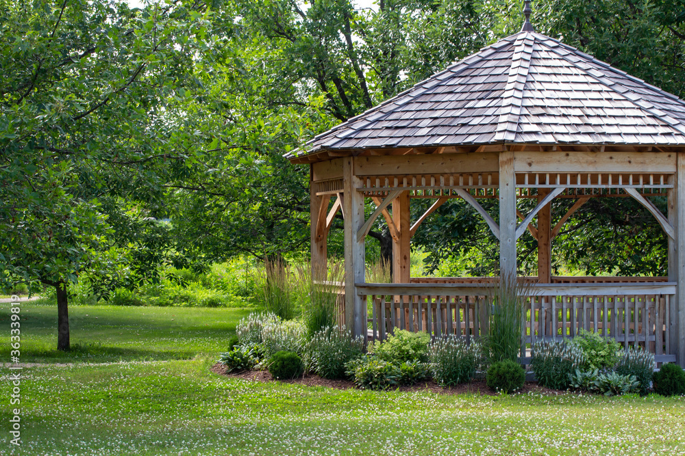 Scenic rural tree lined landscape with wooden gazebo Stock Photo ...