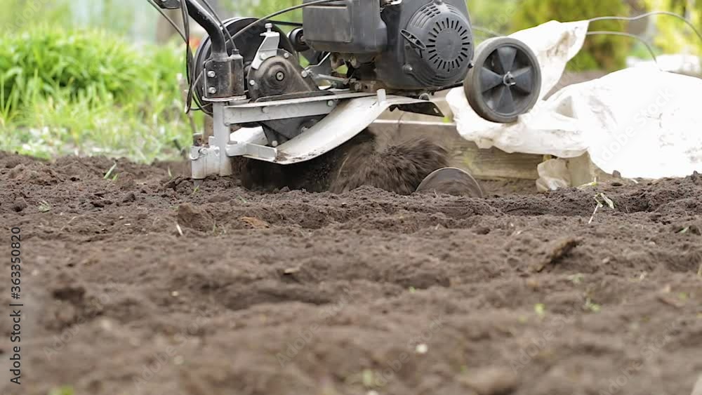 Man farmer working in field ploughing the land with a plough on a farm ...