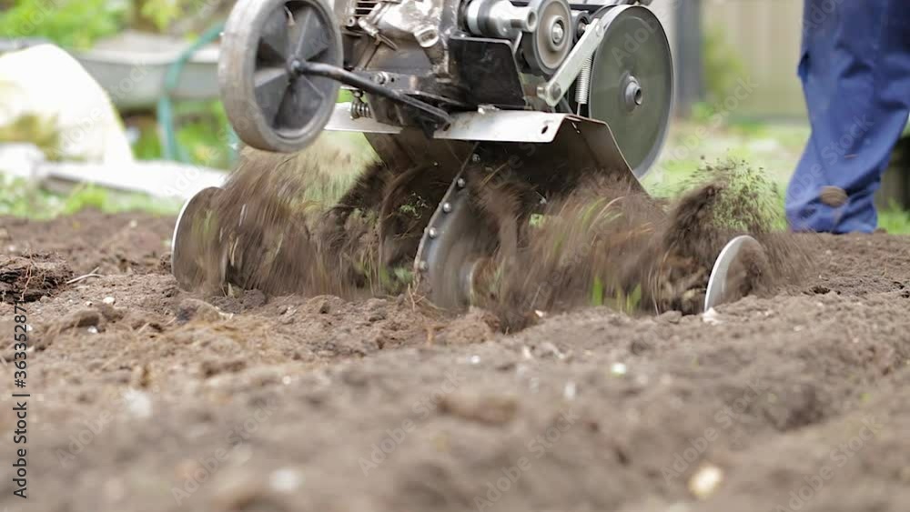 Man farmer working in field ploughing the land with a plough on a farm ...