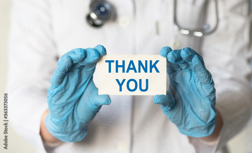 Doctor holding card with text Thank you. Stock Photo | Adobe Stock