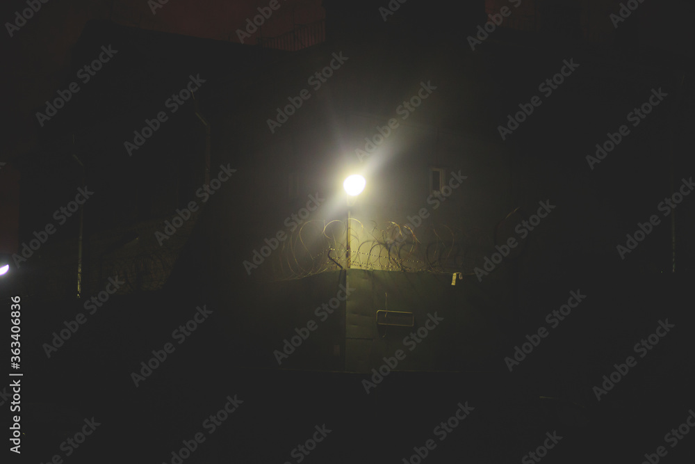 A night view of protected creepy penitentiary prison building facility ...