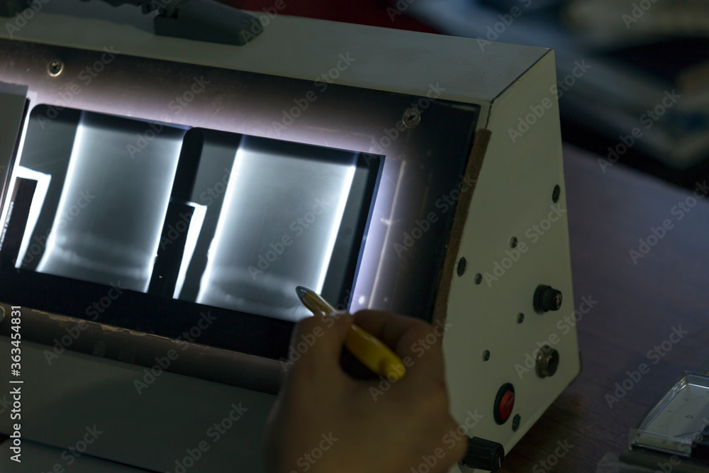 The inspector review weld of the pipe on the radiographic film ...