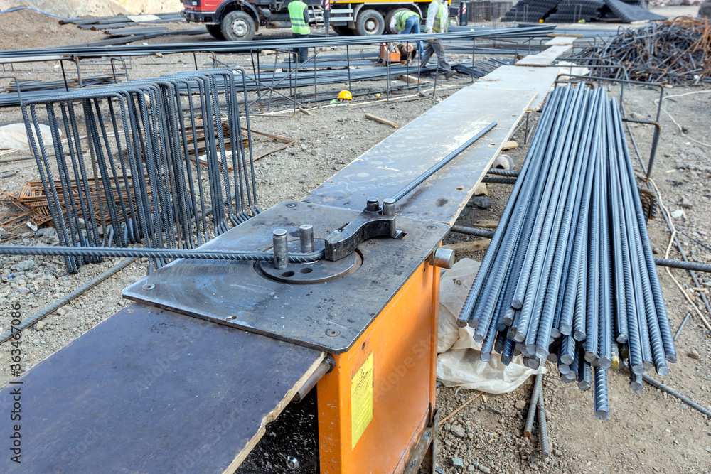 The worker is bending rebars with rebar bending machine in the site ...