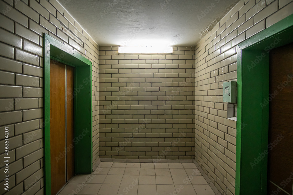 Room with elevators of a Soviet apartment building of the 80s, lined ...