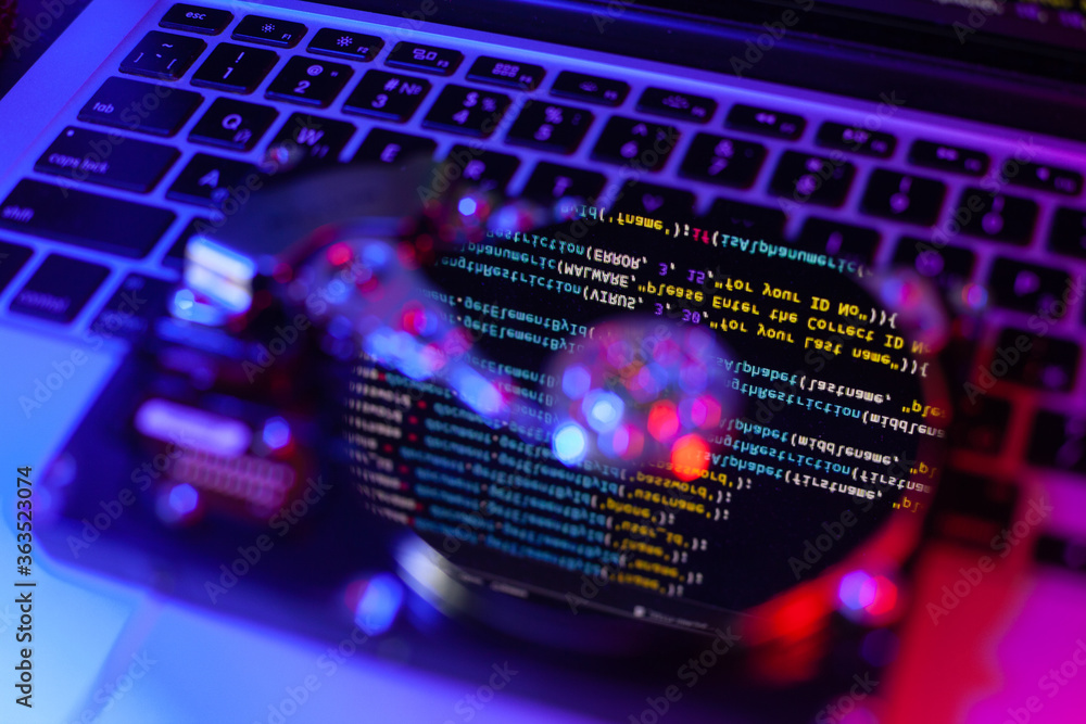 Hard drive on a laptop keyboard. Reflection of program code from the ...