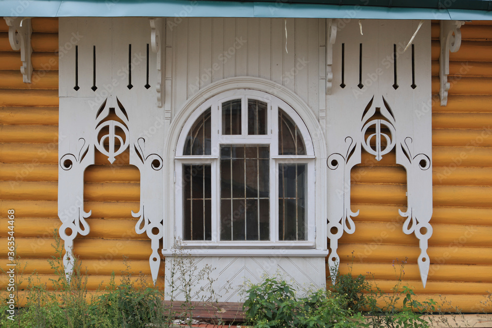 Richly decorated ornamental carved window, frame on vintage wooden ...