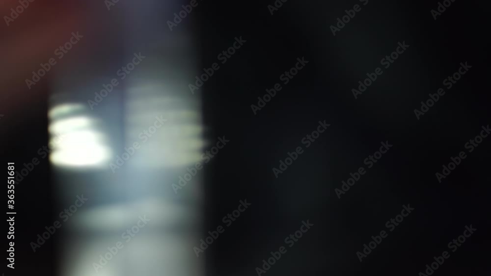 glass prism rotating in front of camera lens, real in camera light ...