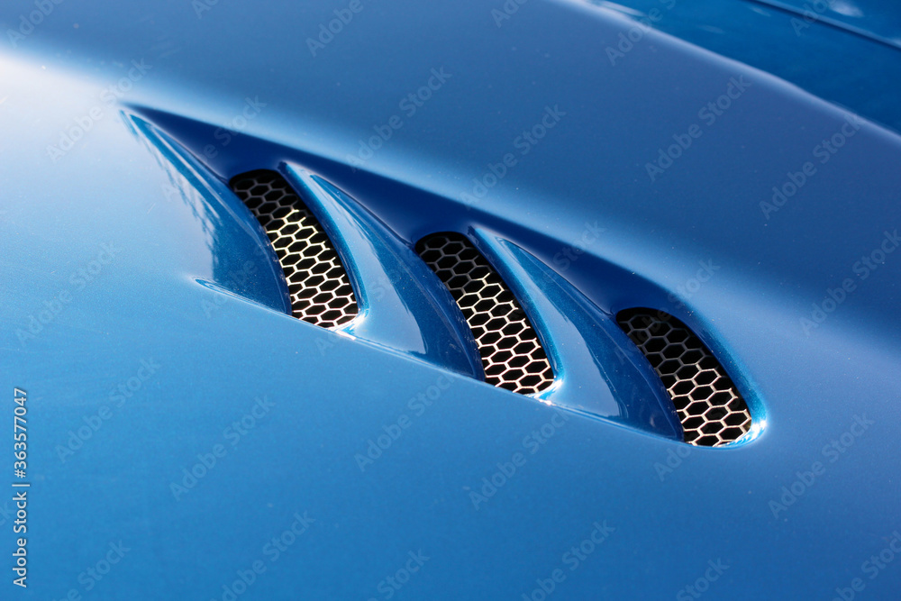 Foto de Ventilation ducts in blue sports car hood do Stock | Adobe Stock