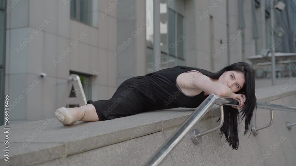 Side view portrait of charming young confident woman bending forward as ...