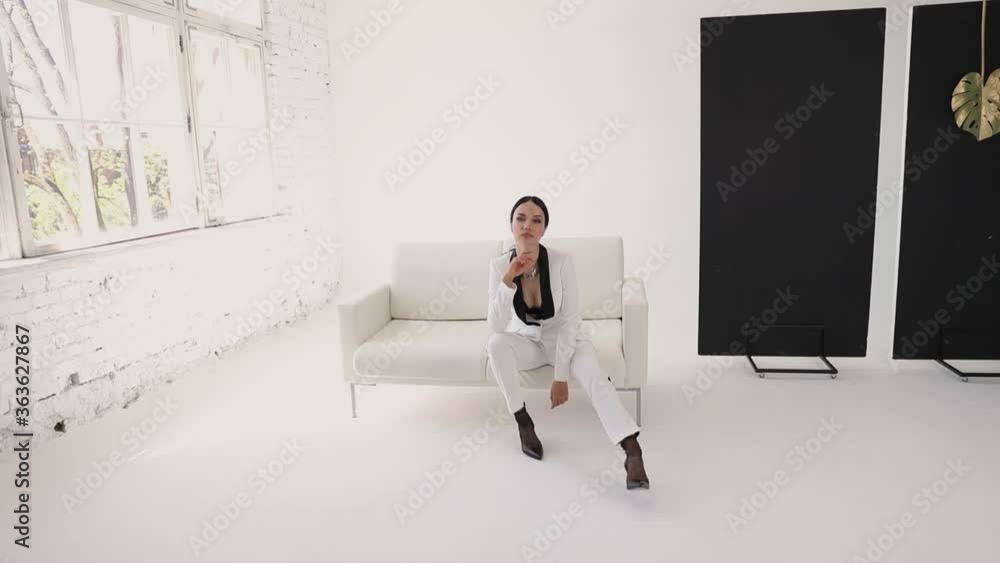 Girl model poses for camera, looks directly into lens, operator's work ...