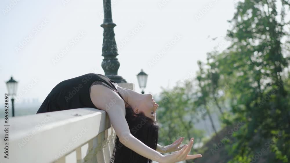 Beautiful brunette Caucasian woman bending over stairs handrails on ...
