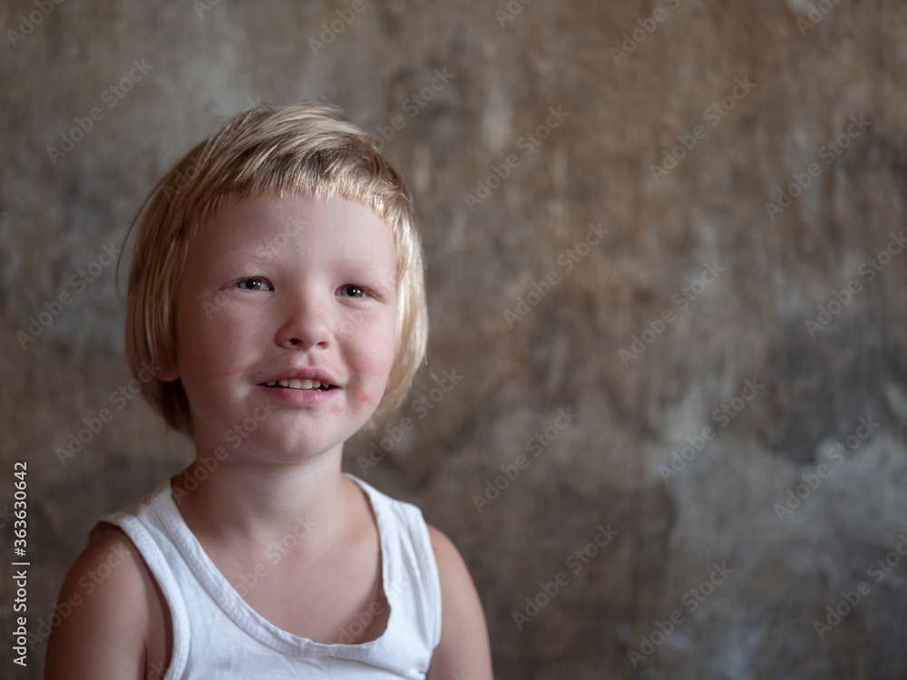 little fair-haired boy is smeared with blood. baby has weak vessels in ...