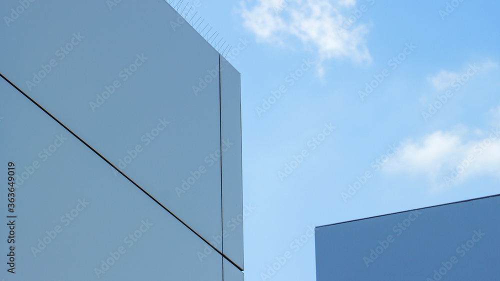 two geometric fragments of a modern building against the blue sky.Urban ...