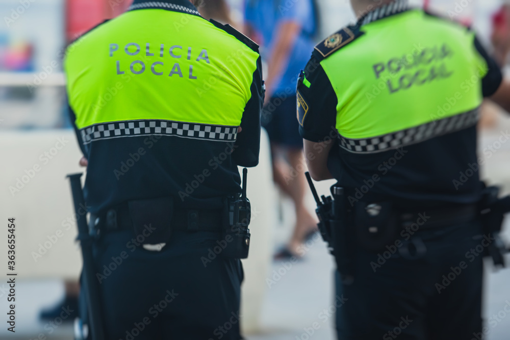 Spanish police squad formation back view with "Local Police" logo ...
