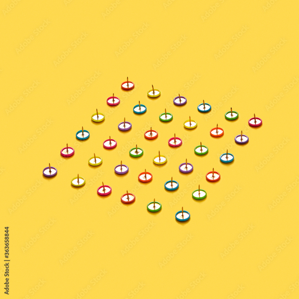 Square pattern of colored pins on an yellow background. Stock Photo ...